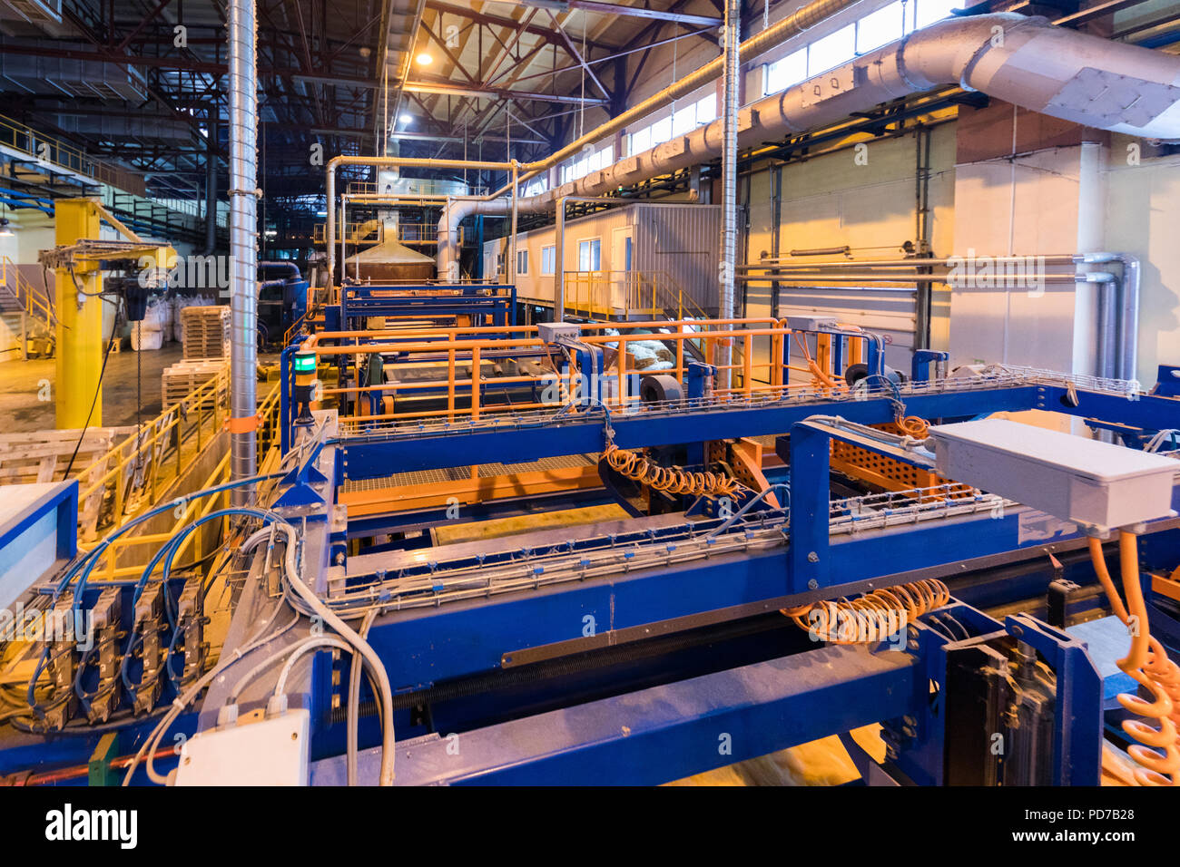 Fiberglass production industry equipment at manufacture background ...