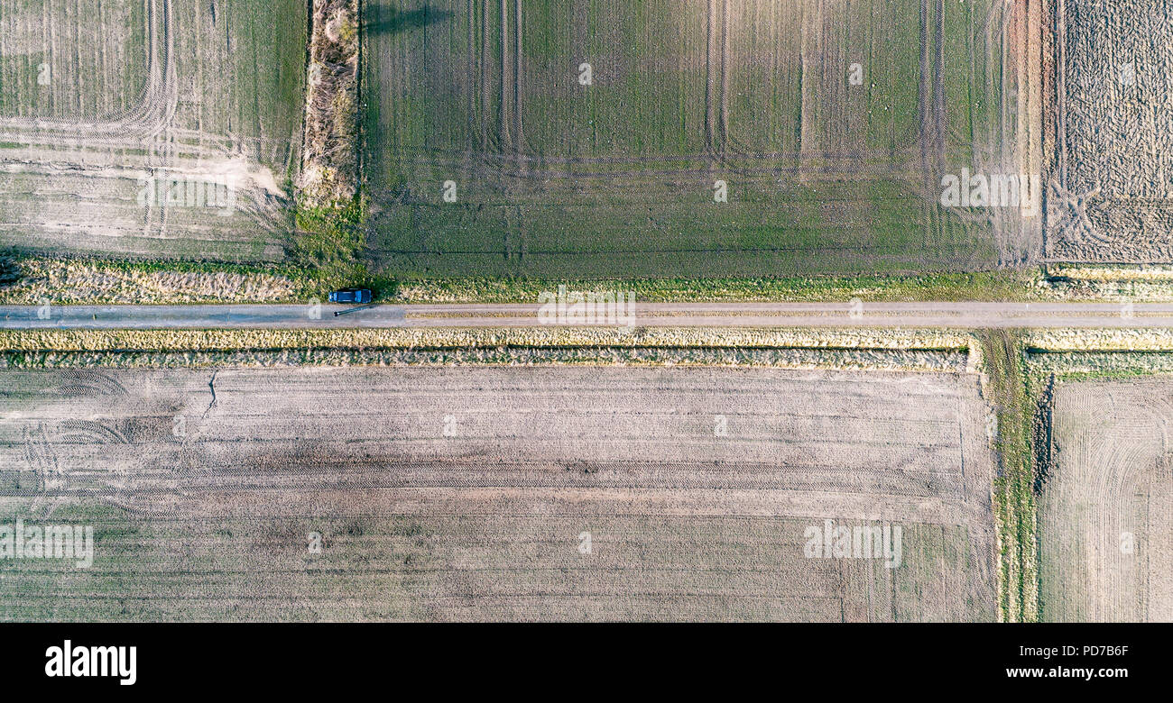 Abstract aerial view, vertical view of a straight dirt road between ...