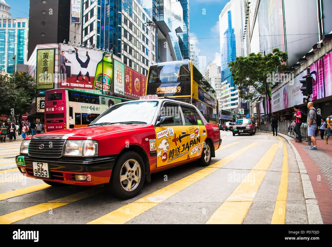 HONG KONG - APR 3, 2016: Urban red taxi in Hong Kong urban landscape on ...