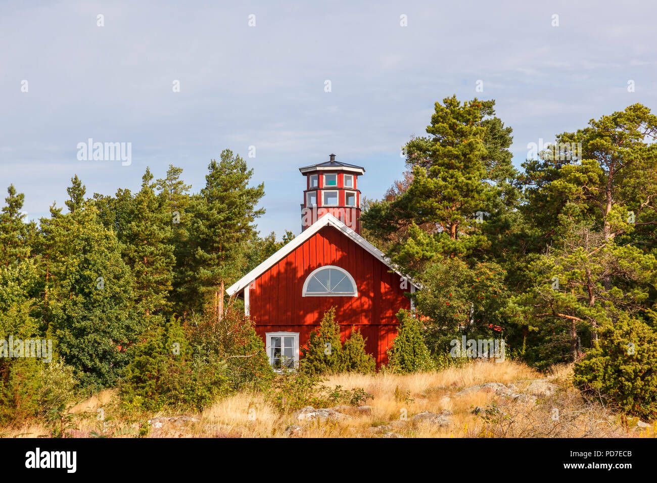 Old red lighthouses in the forest on an island Stock Photo - Alamy