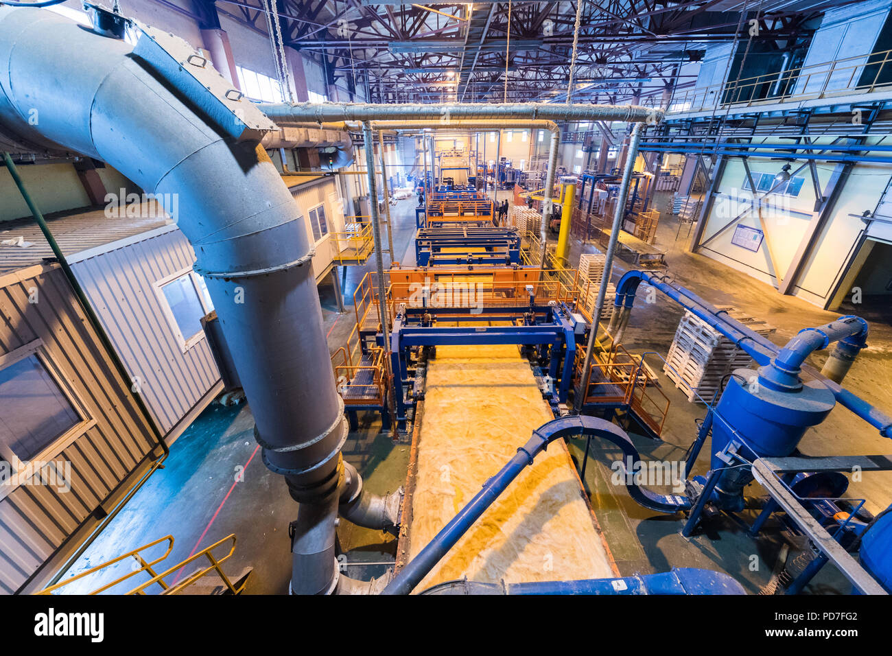 Fiberglass production industry equipment at manufacture background ...