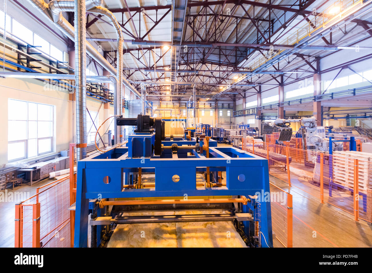 Fiberglass production industry equipment at manufacture background ...