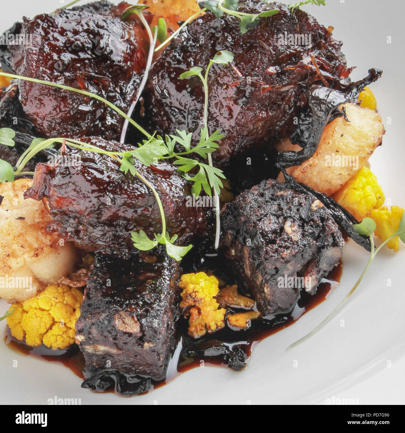 pigs cheek scallop black pudding starter Stock Photo - Alamy