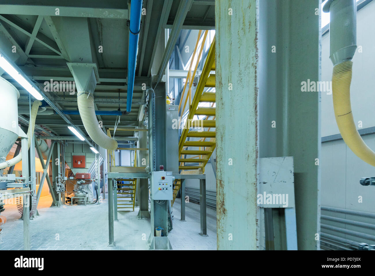 Fiberglass production industry equipment at manufacture background ...