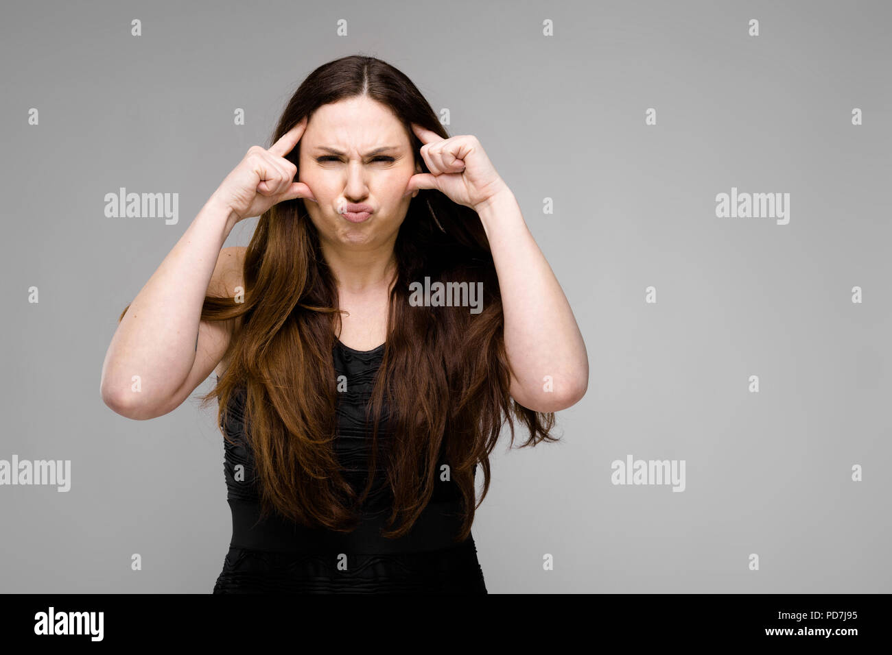 Emotional confident plus size model standing in studio angry fed up on ...