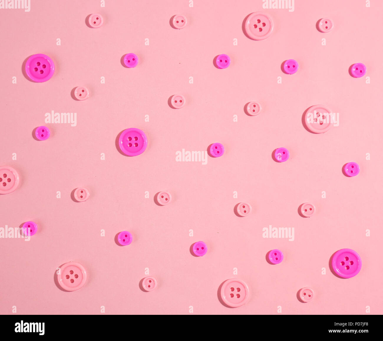 flat lay top view pink buttons pattern isolated on pastel soft pink ...