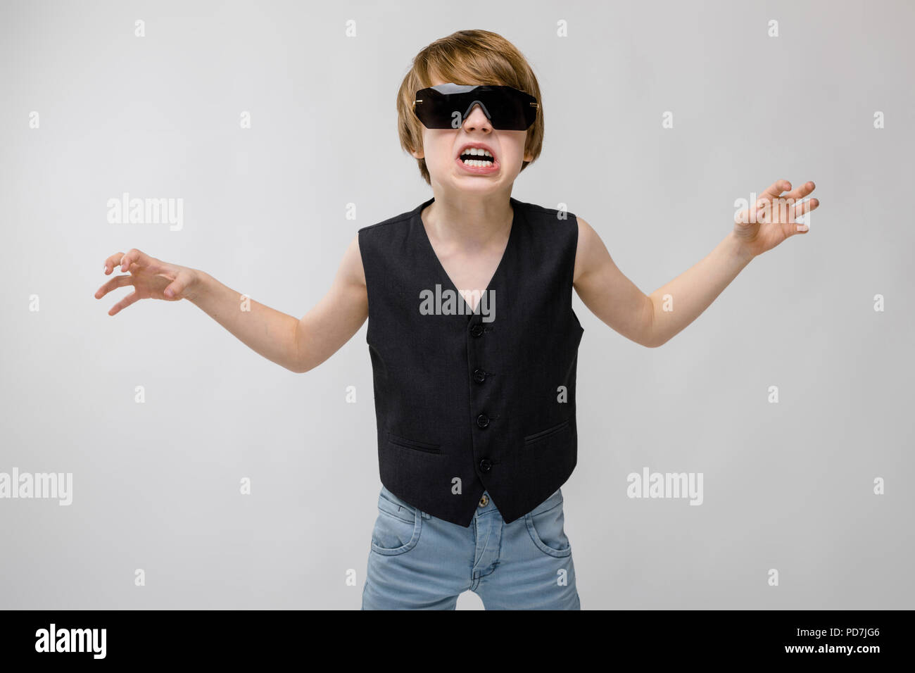 Portrait of adorable funny little boy standing in studio with ...