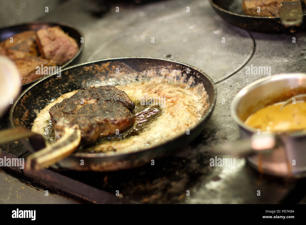 cooking fresh steak in kitchen Stock Photo - Alamy