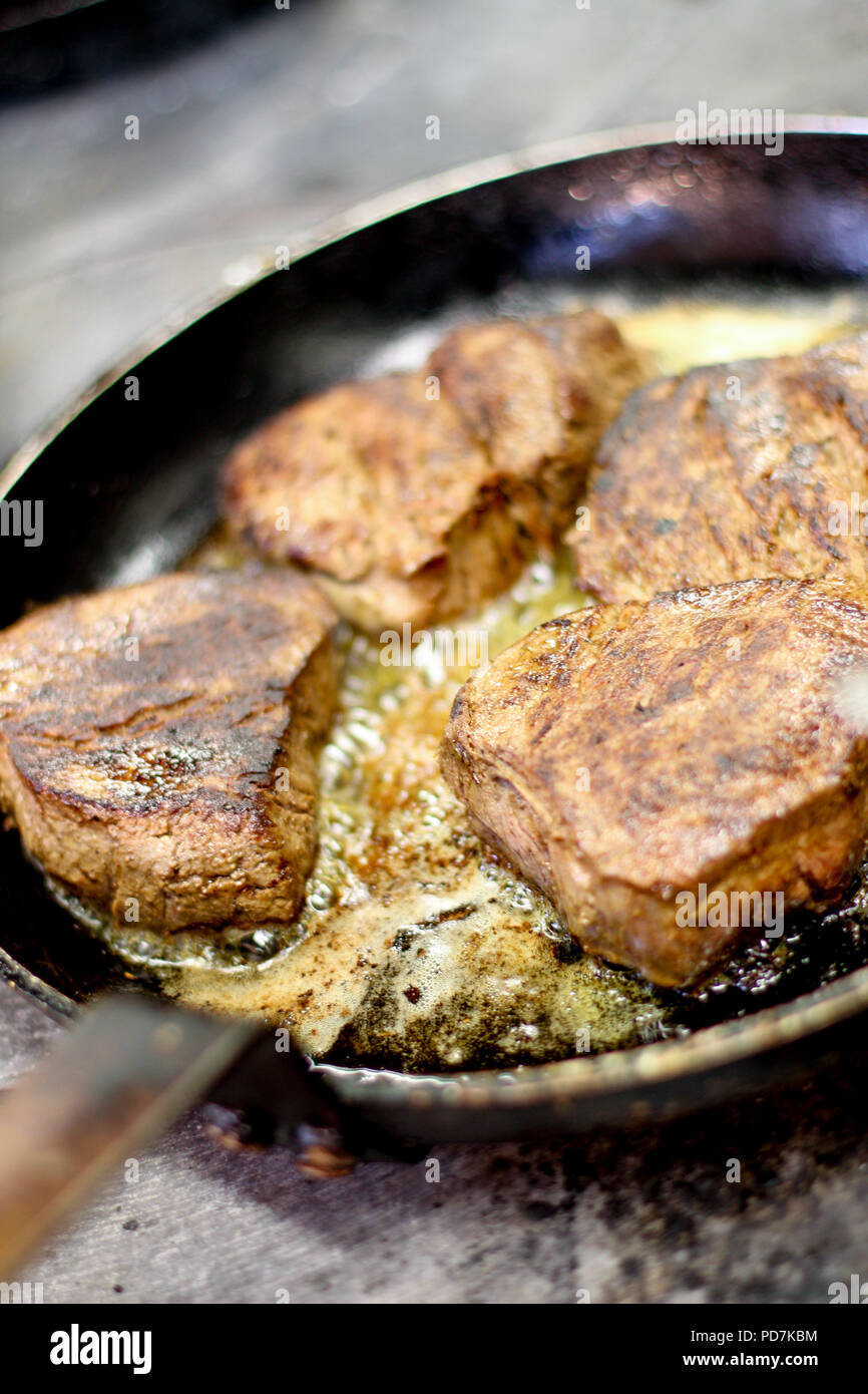 cooking fresh steak in kitchen Stock Photo - Alamy