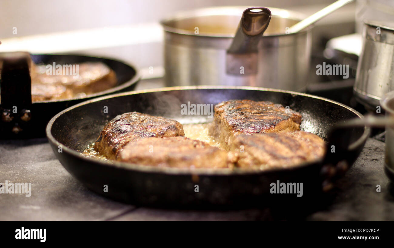 cooking fresh steak in kitchen Stock Photo - Alamy