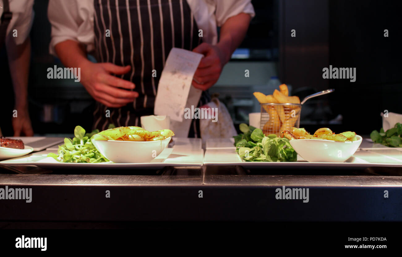 plating food in kitchen Stock Photo - Alamy