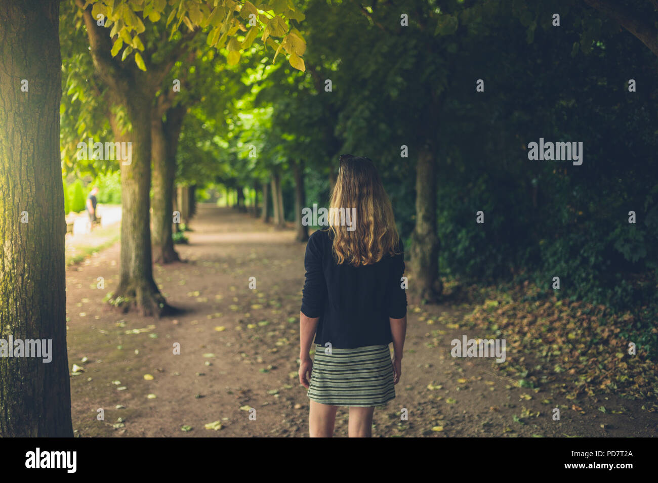 Woman walking promenade trees hi-res stock photography and images - Alamy
