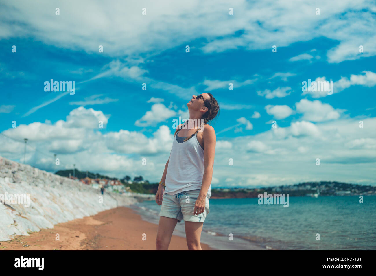 Woman at the beach looking up hi-res stock photography and images - Alamy