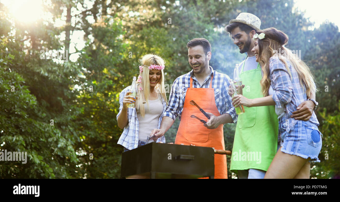 Happy people having camping and having bbq party Stock Photo - Alamy
