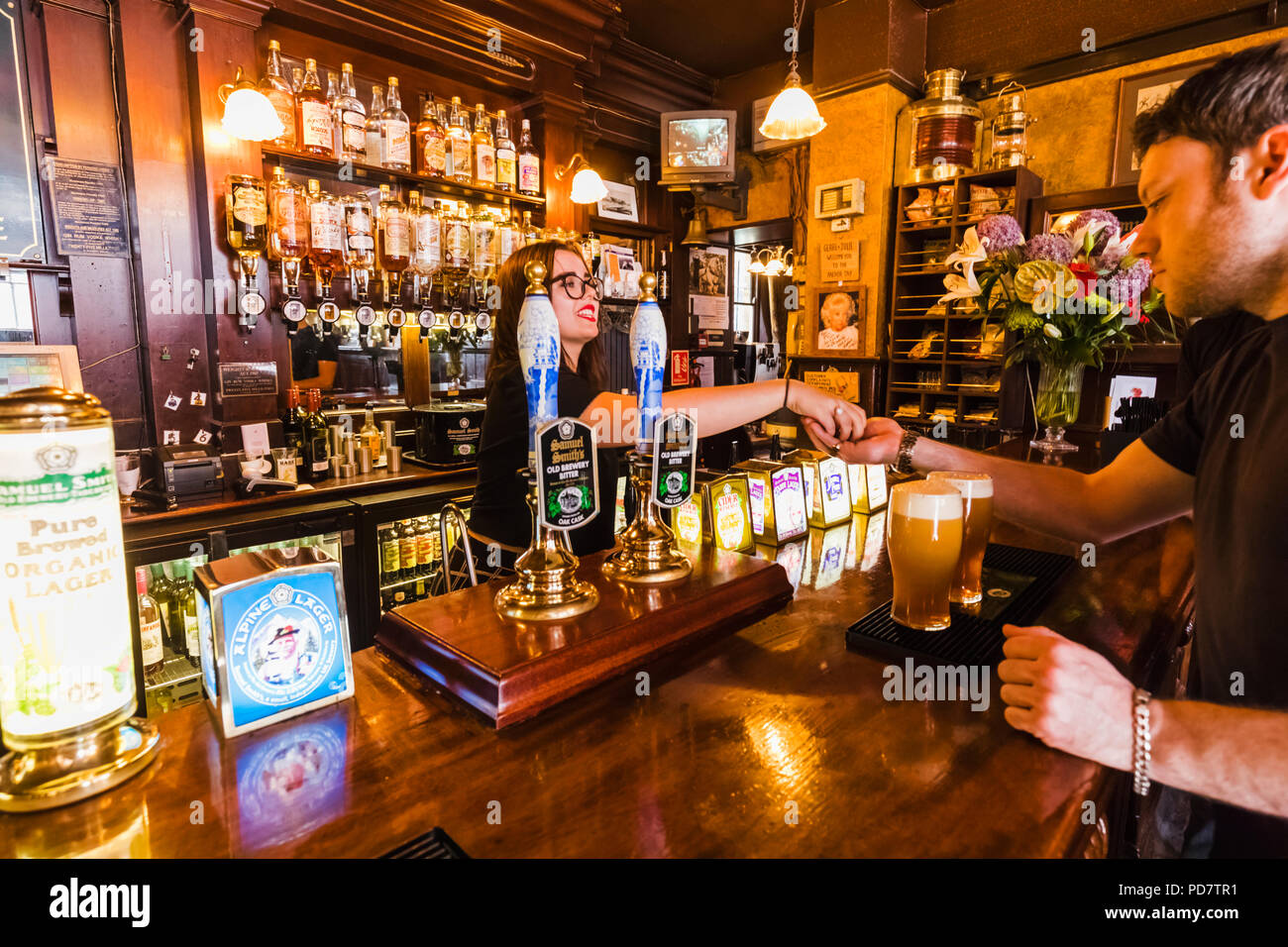 England, London, Southwark, Anchor Tap Pub, Barmaid Serving Customer ...