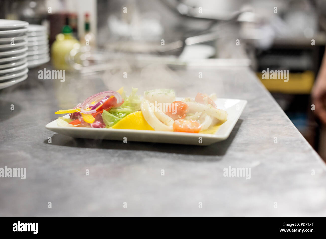 Chef preparing serving food in Italian restaurant kitchen Stock Photo ...