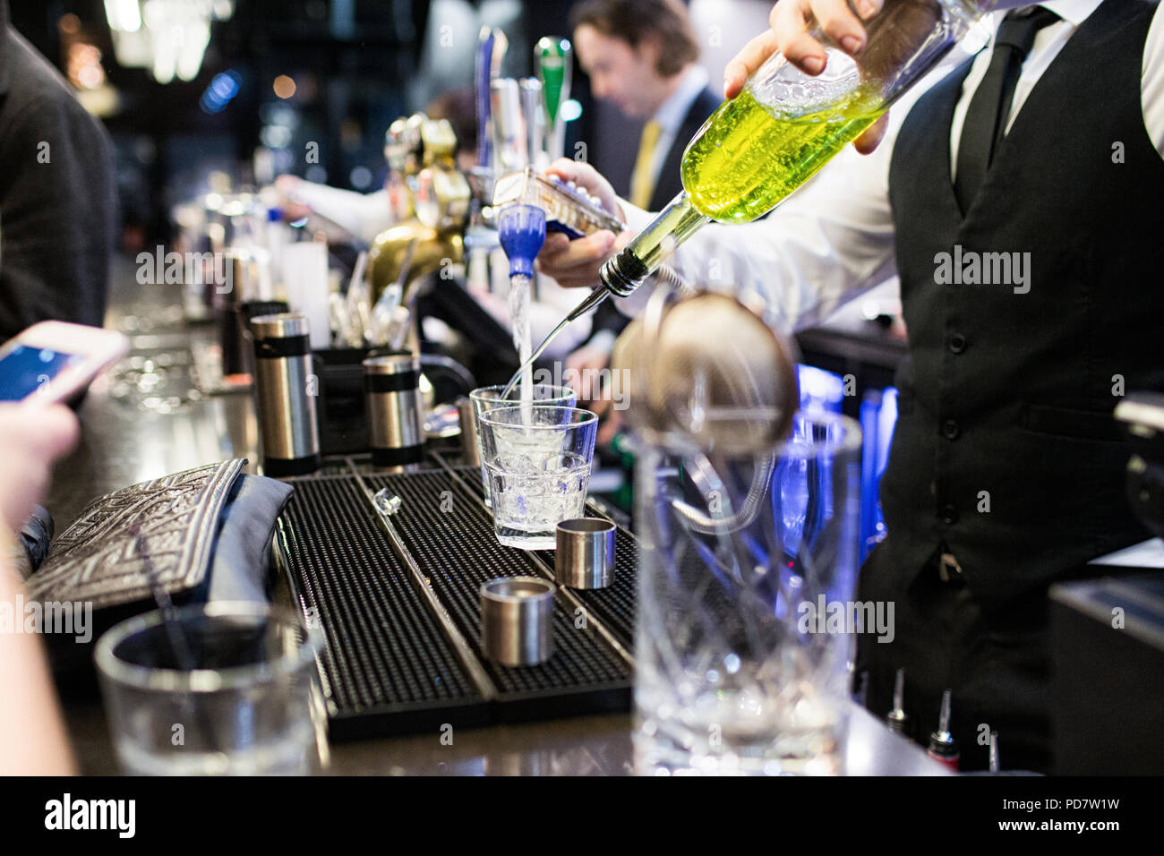 Bartender preparing drinks for customers hi-res stock photography and ...