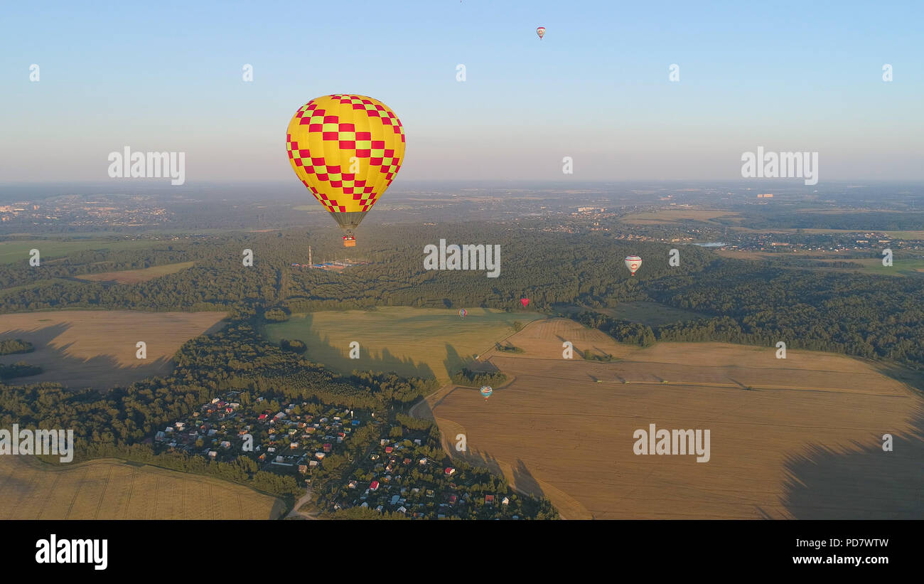 Aerial view Hot air balloons in sky over fields in countryside ...