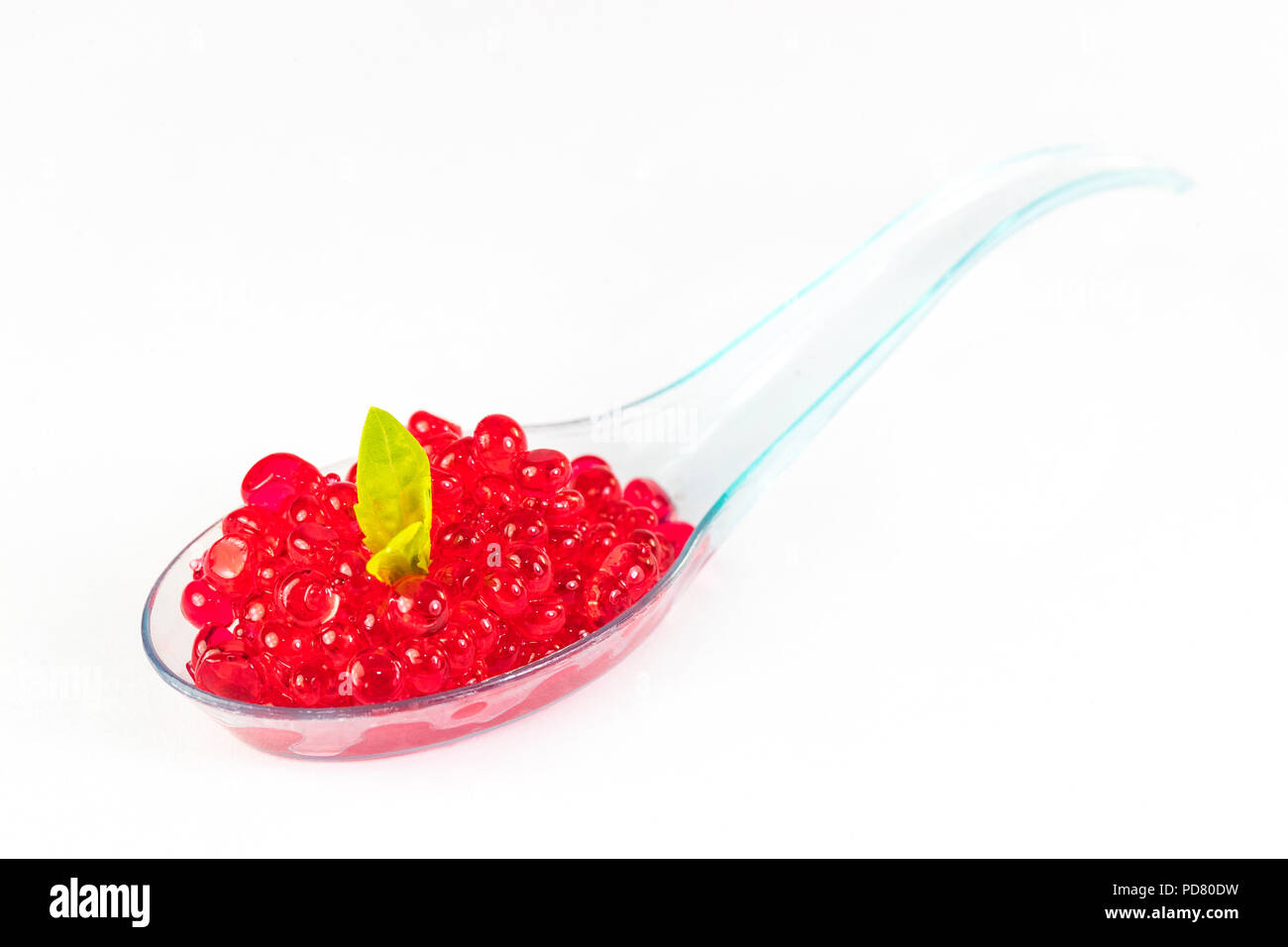 Plastic spoons with fish caviar on a white background Stock Photo - Alamy