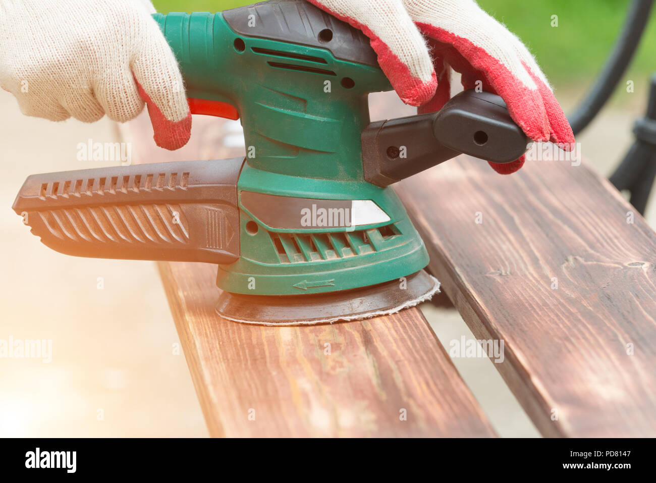 Sanding a wood with orbital sander outdoor Stock Photo - Alamy