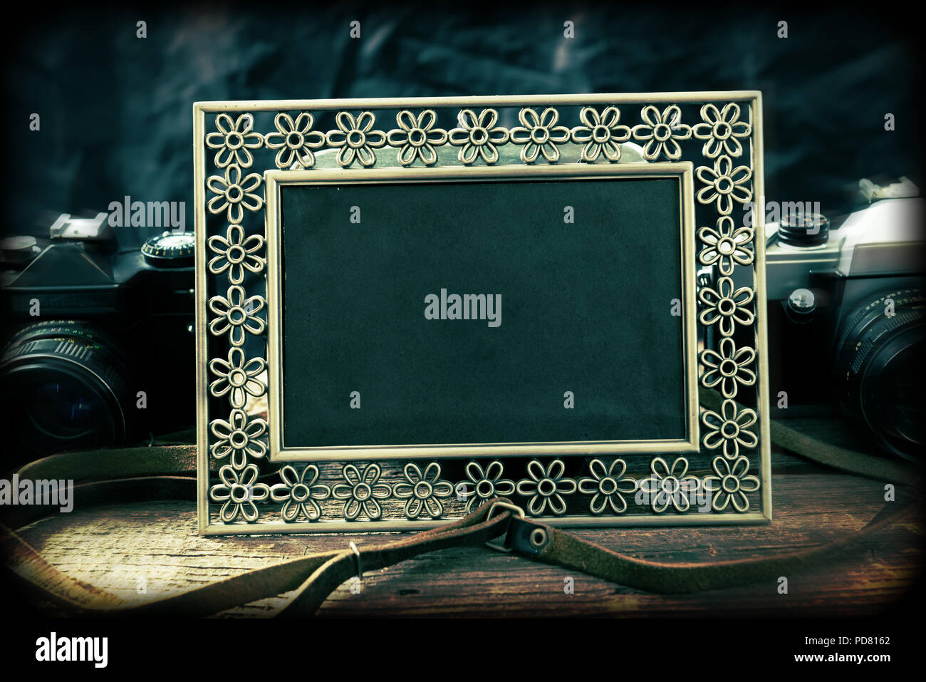 Old photographic cameras with photo frame on wooden desk Stock Photo ...