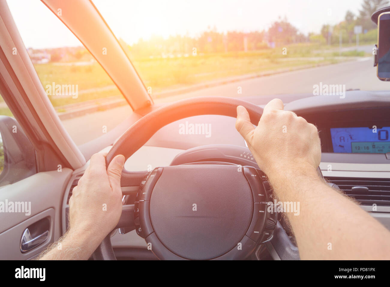 Driving a car - first person view. Hands on steering wheel Stock Photo ...