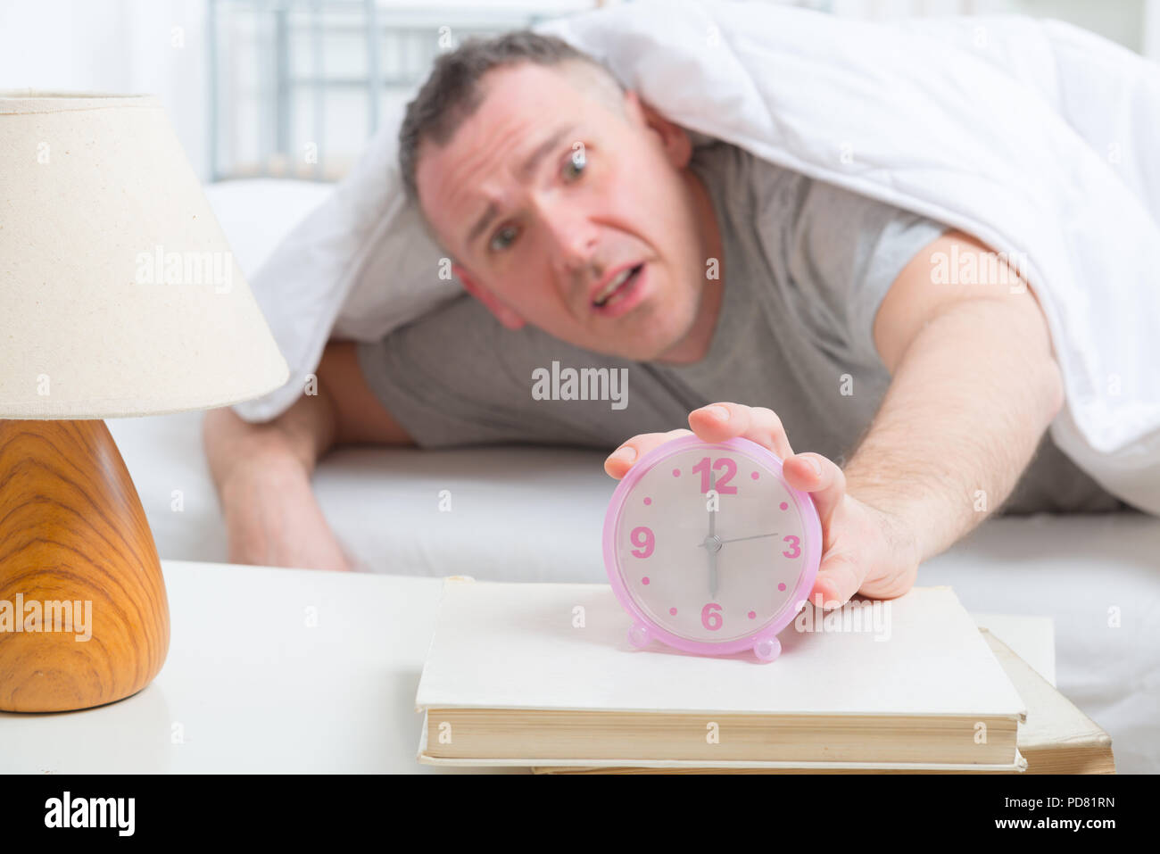 Hand on clock, time to wake up Stock Photo - Alamy