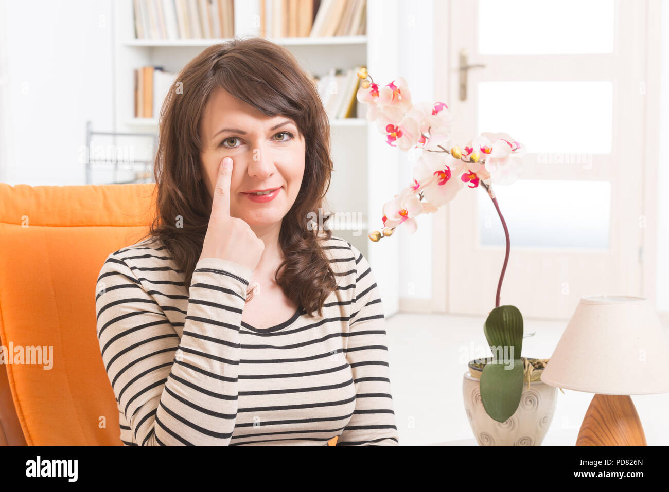 Woman doing EFT on the under eye point. Emotional Freedom Techniques ...