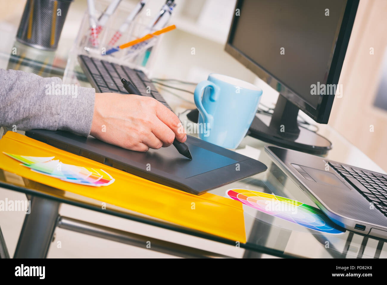 Designer using graphics tablet in the office Stock Photo - Alamy