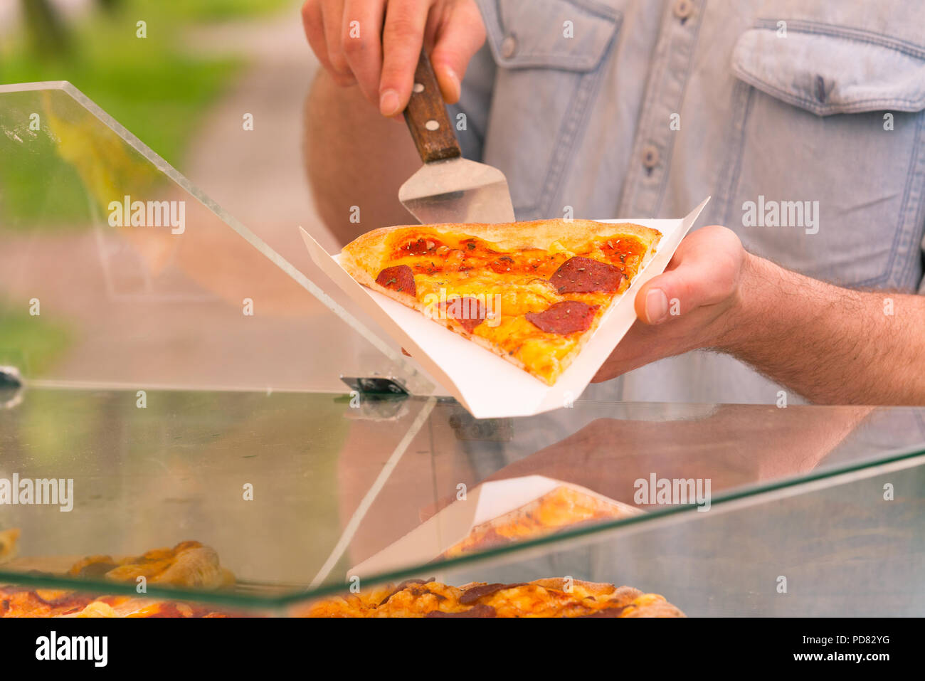 A street food vendor selling pizza by slice outdoors Stock Photo - Alamy