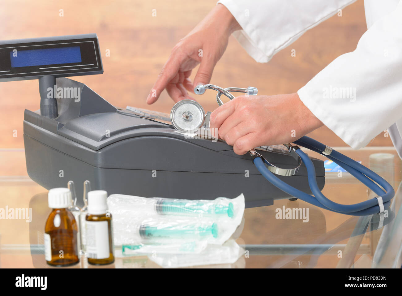 pharmacist or medical doctor holdnig stethoscope and using cash ...