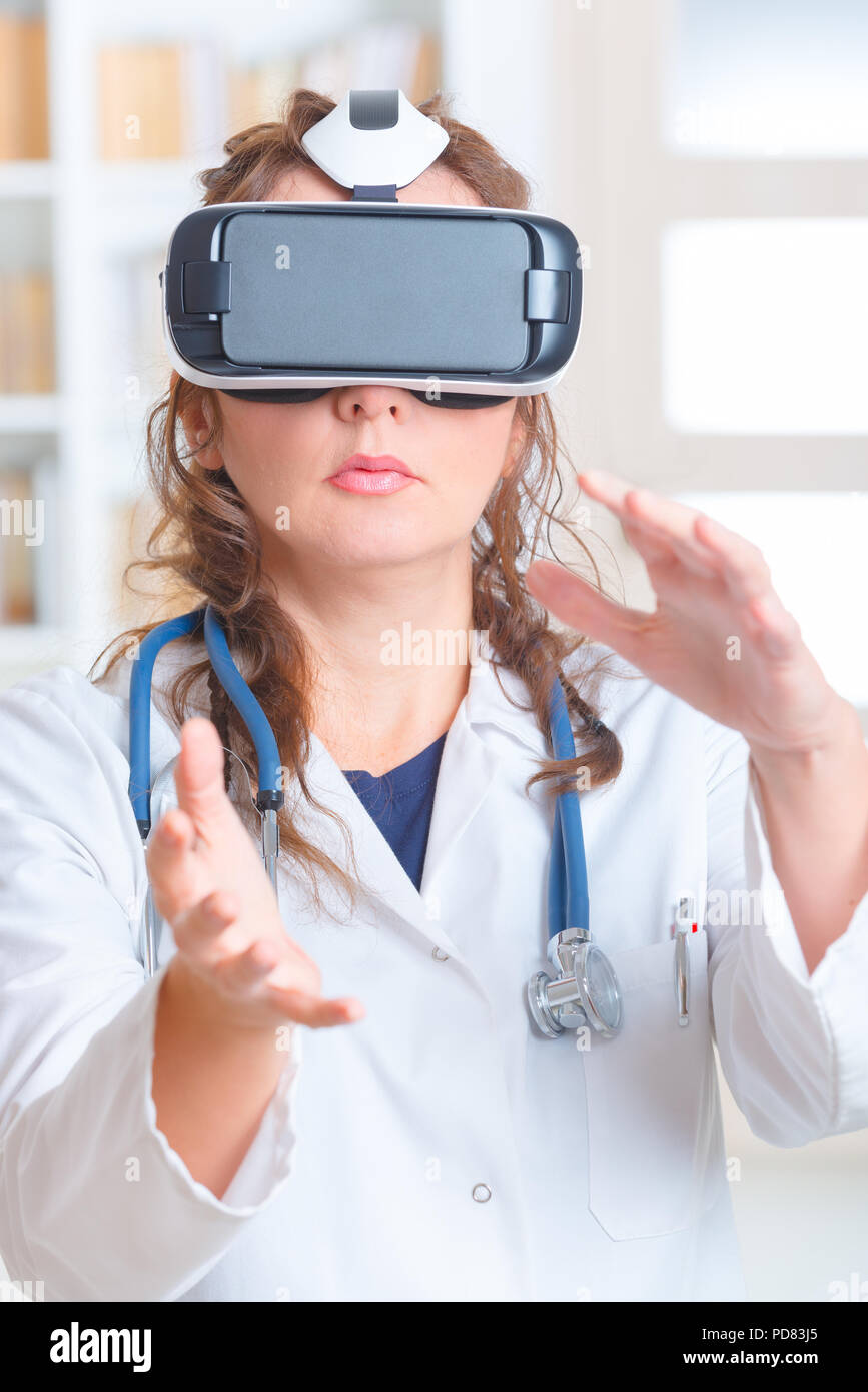 Medical doctor using virtual reality headset at the consulting room ...