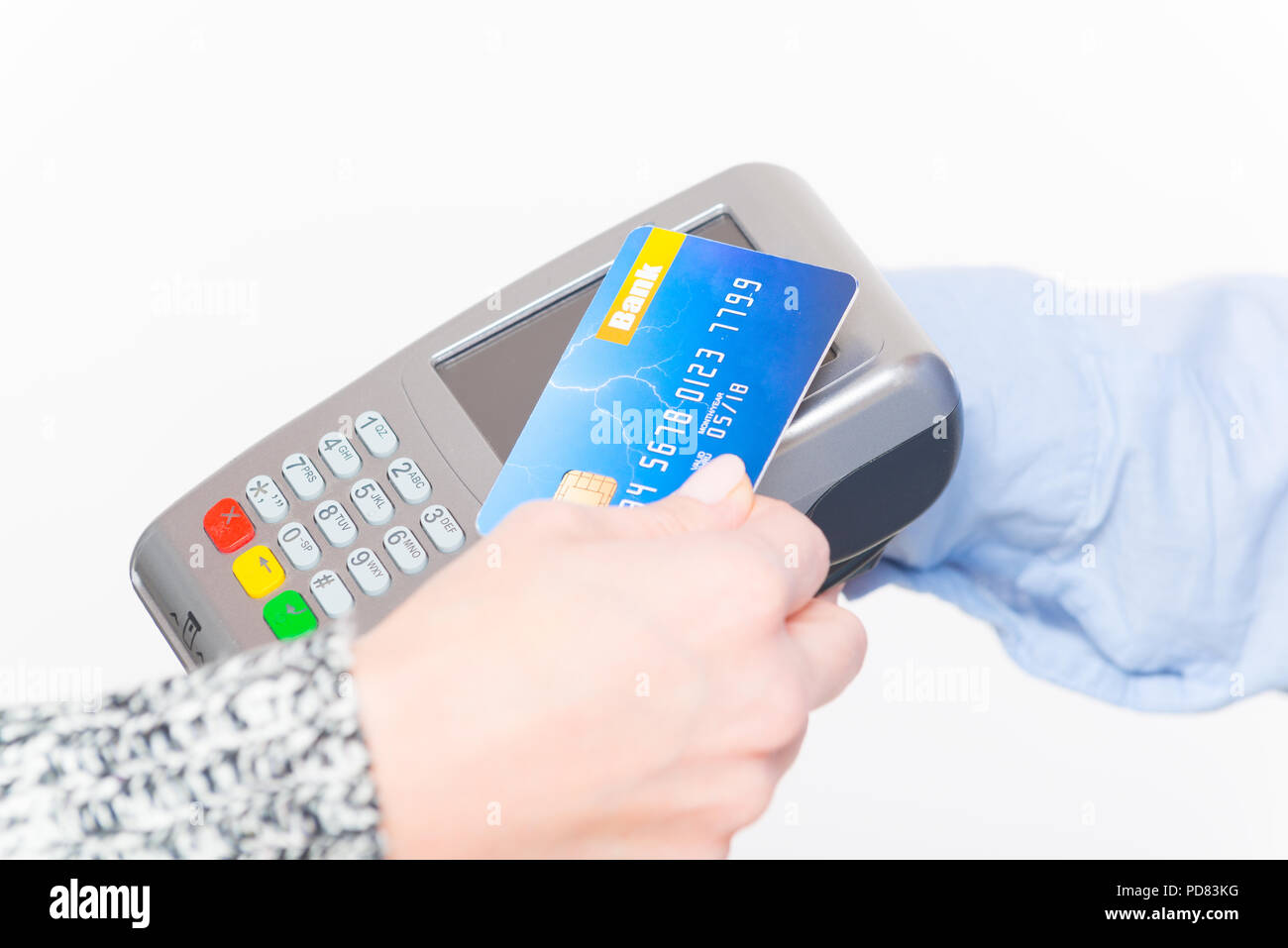 Hand holding contactless credit or debit card over wireless payment ...