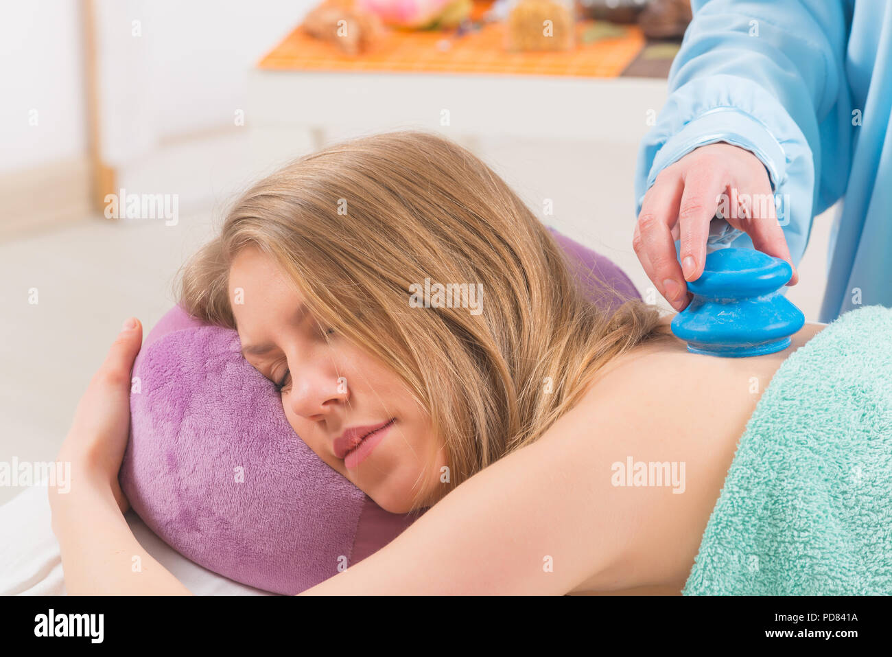 Therapist doing traditional chinese cupping therapy on her patient ...