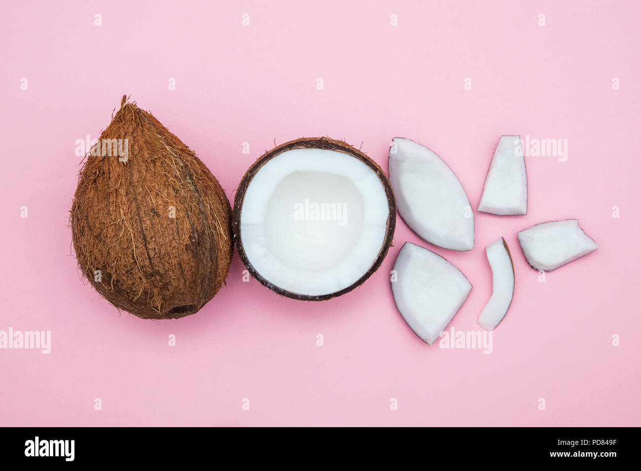Tropical summer coconut on a pastel pink background Stock Photo - Alamy