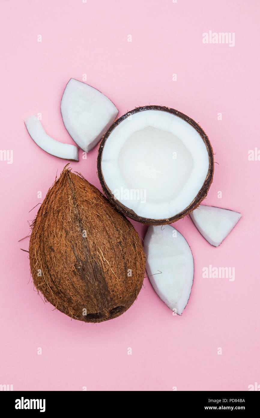 Tropical summer coconut on a pastel pink background Stock Photo - Alamy