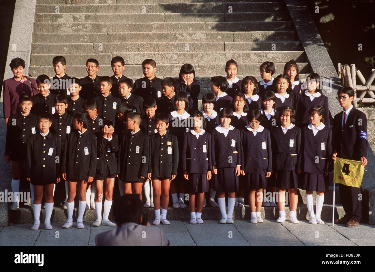 A Japanese school class has set up for the group photo with teacher ...