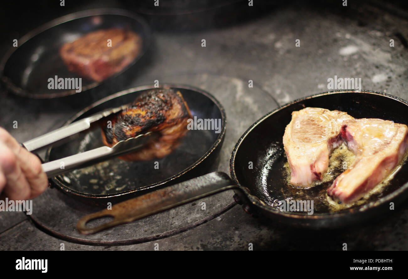 cooking fresh steak in kitchen Stock Photo - Alamy