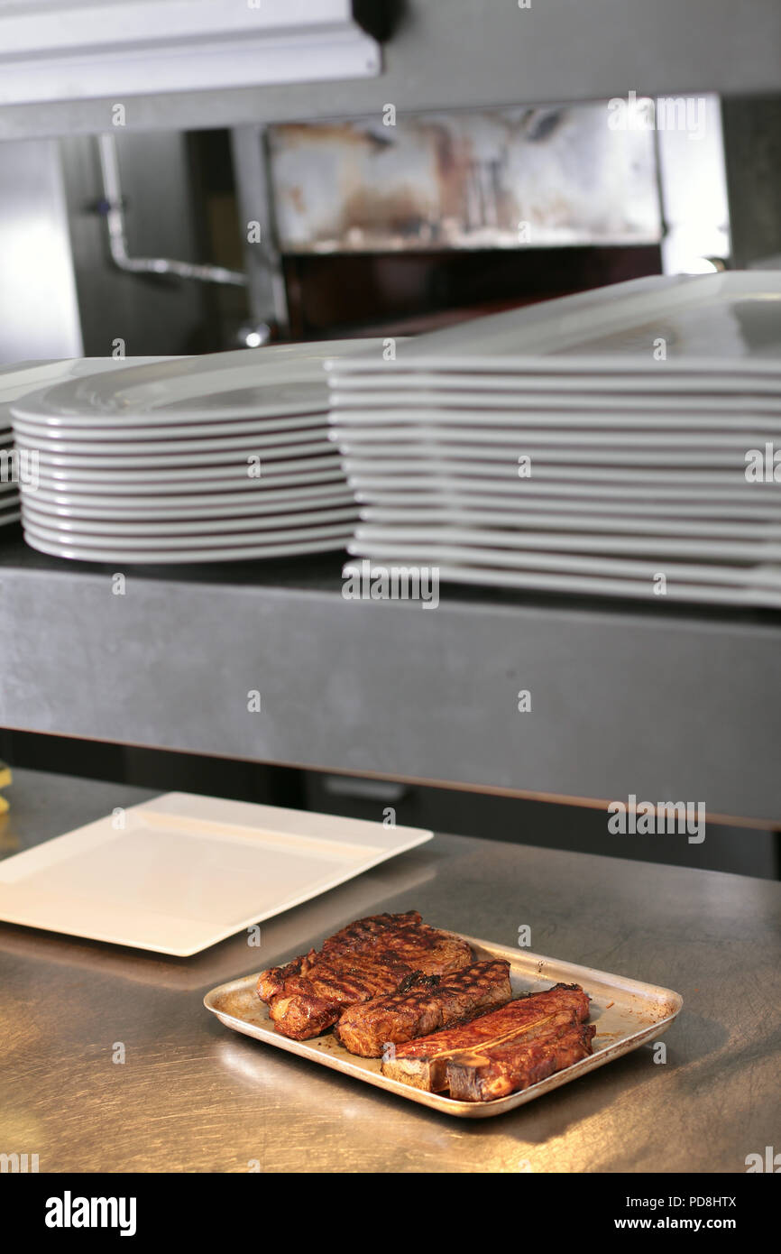 cooking fresh steak in kitchen Stock Photo - Alamy
