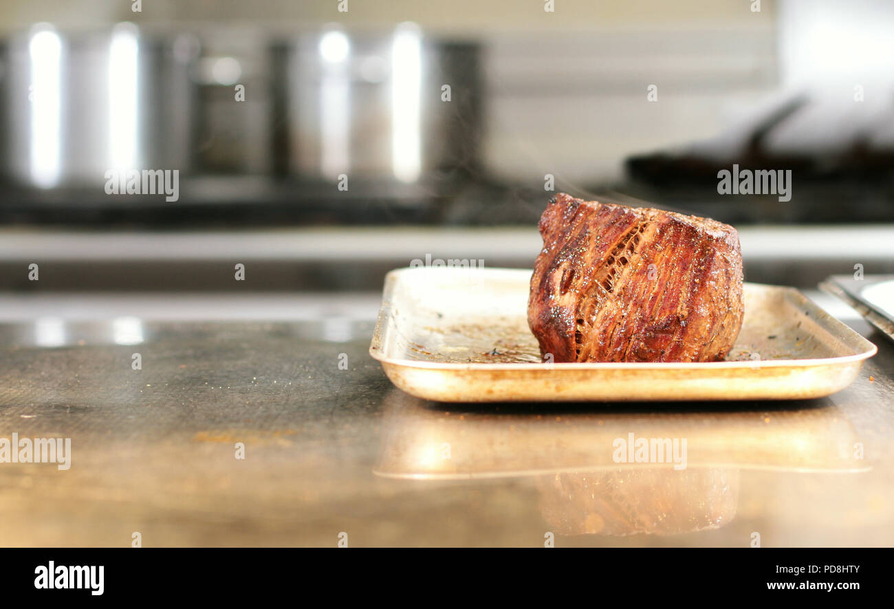 cooking fresh steak in kitchen Stock Photo - Alamy