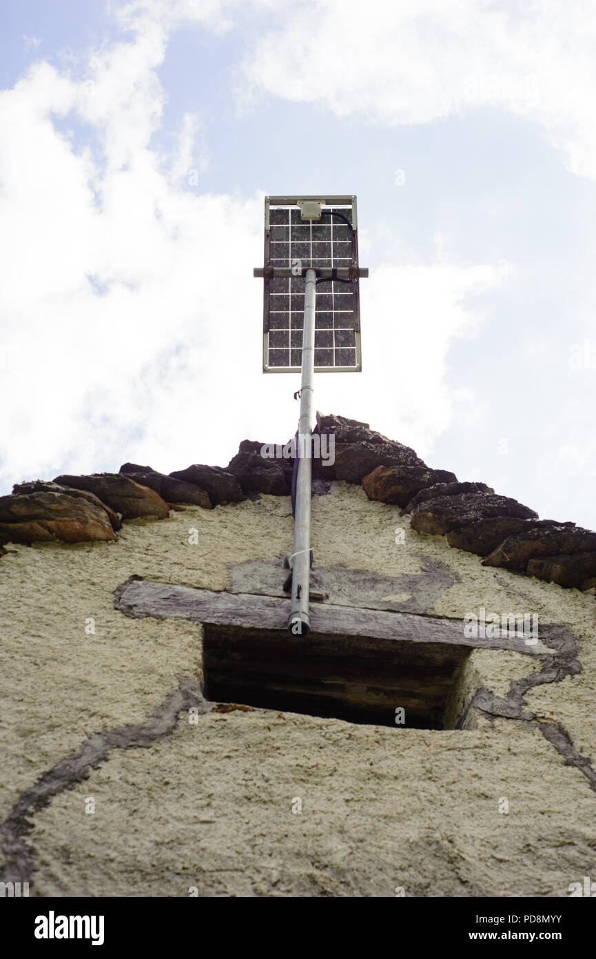 mountain hut with solar panel on the roof for clean and renewable ...