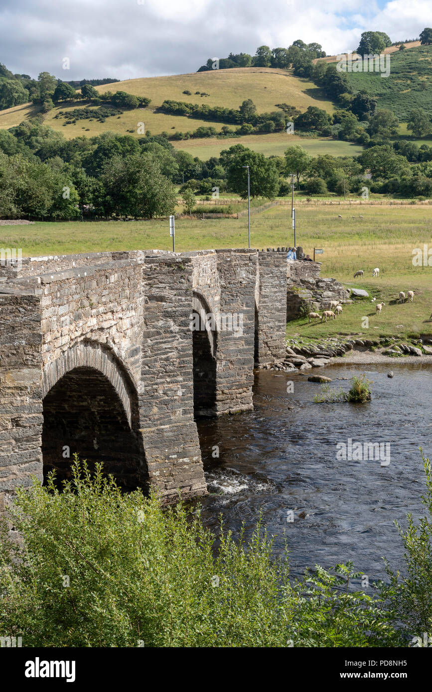 An old stone arched bridge over The River Dee flowing through the Vale ...