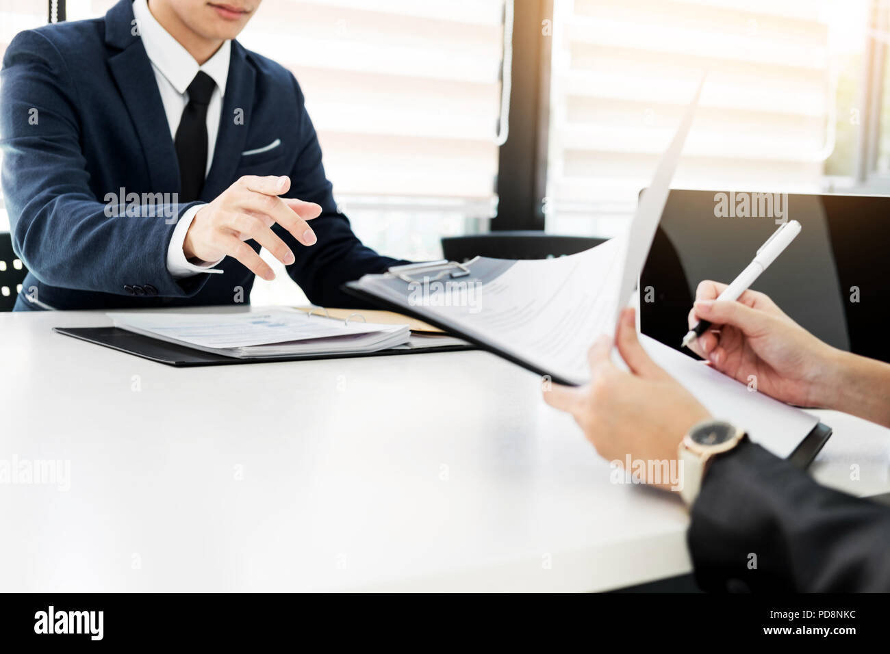 young man explaining about his profile to business managers sitting in ...