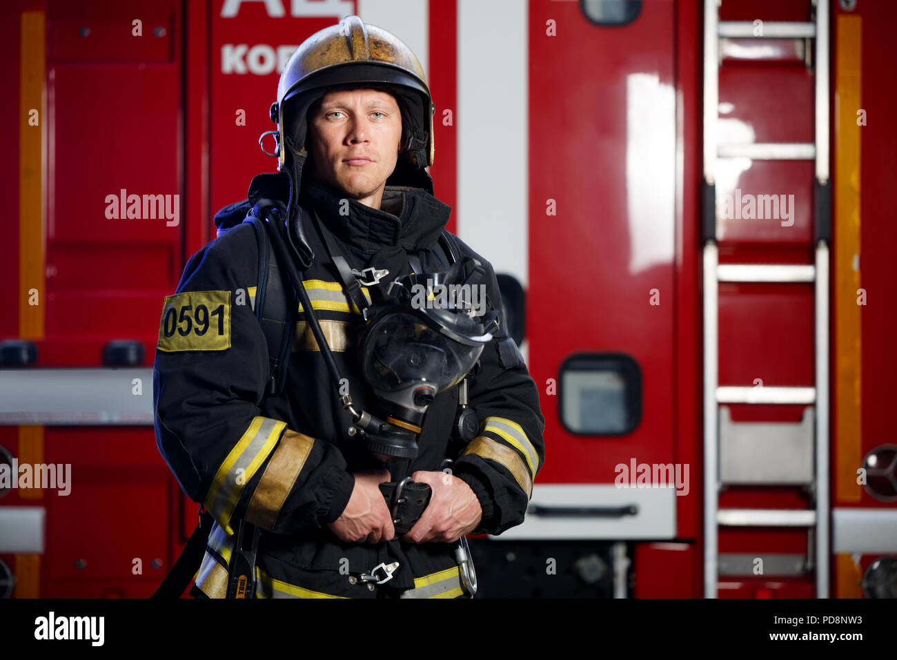 Photo of fireman wearing helmet with gas mask on background of fire ...