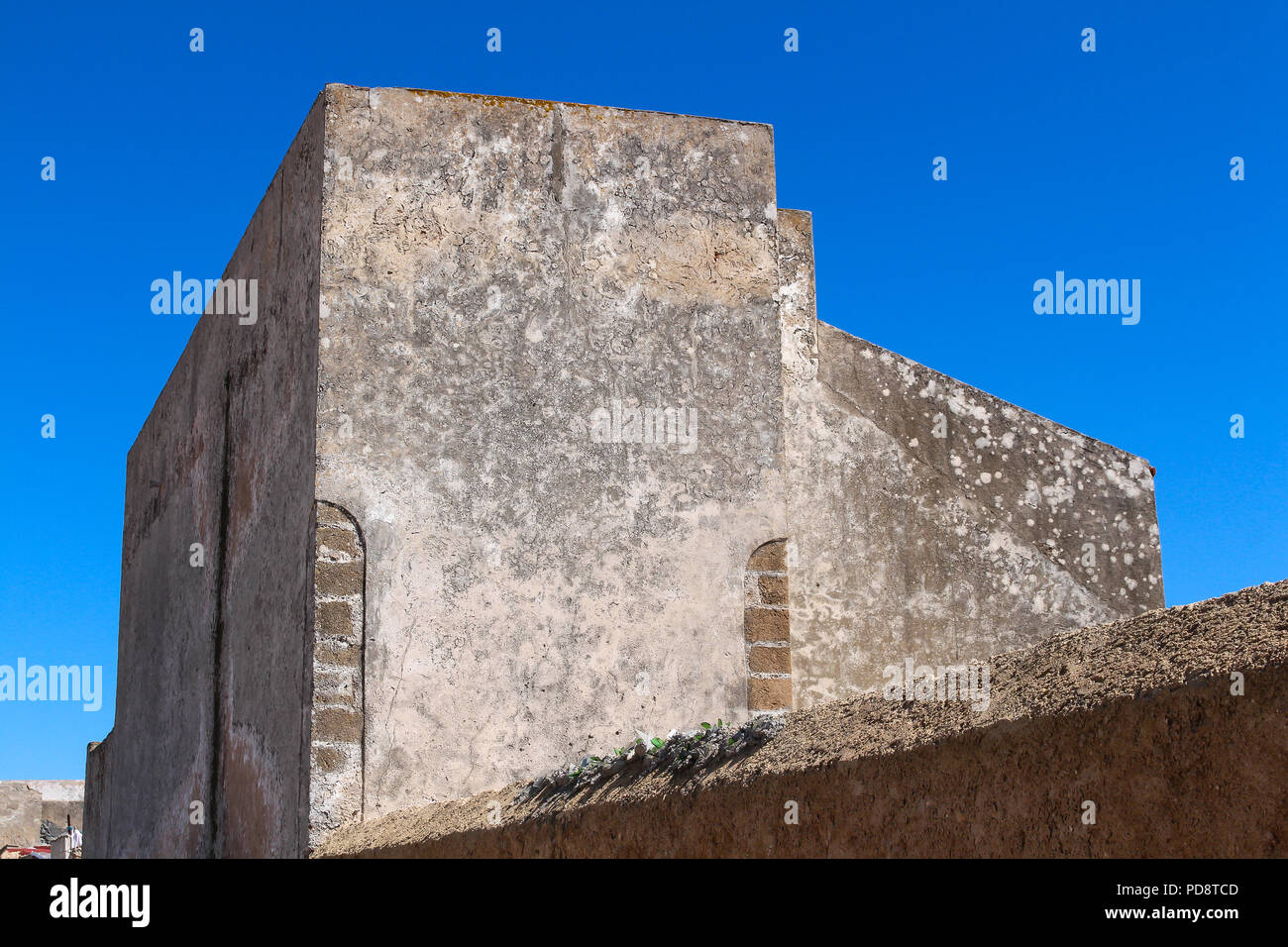 Line of a fortification fence. House with weathered walls and without ...