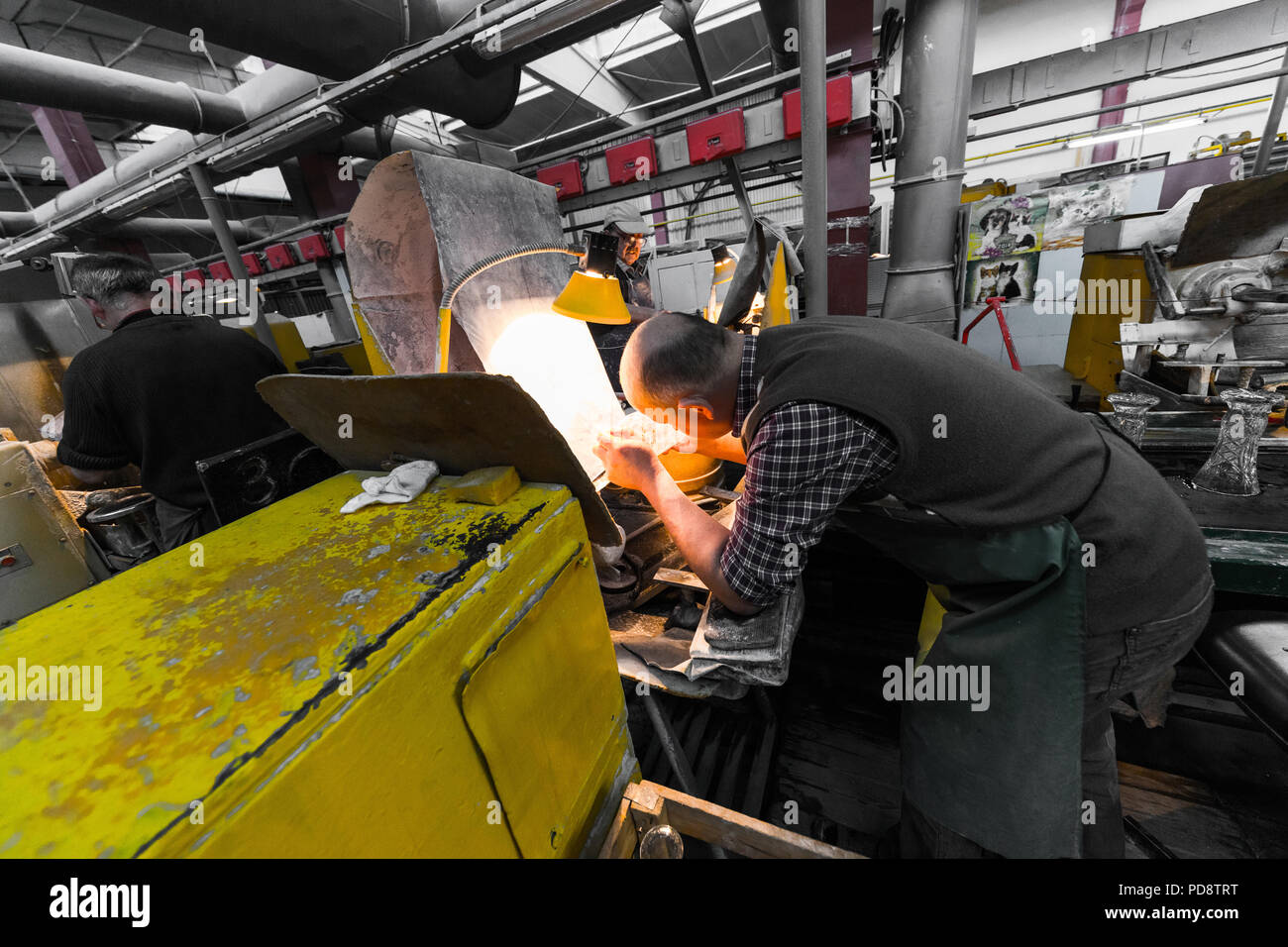 Glass production worker working with industry equipment on factory ...