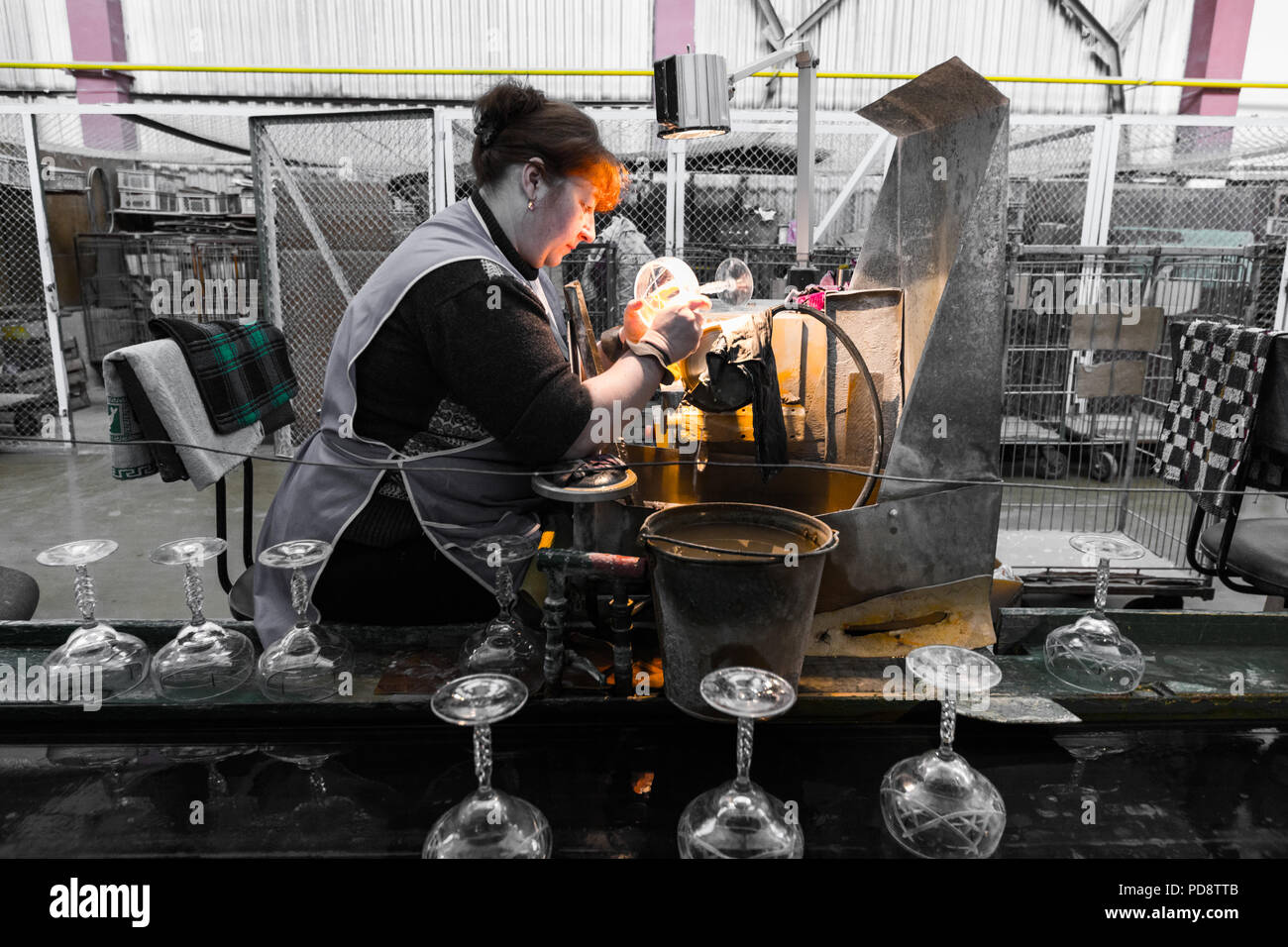 Glass production worker working with industry equipment on factory ...