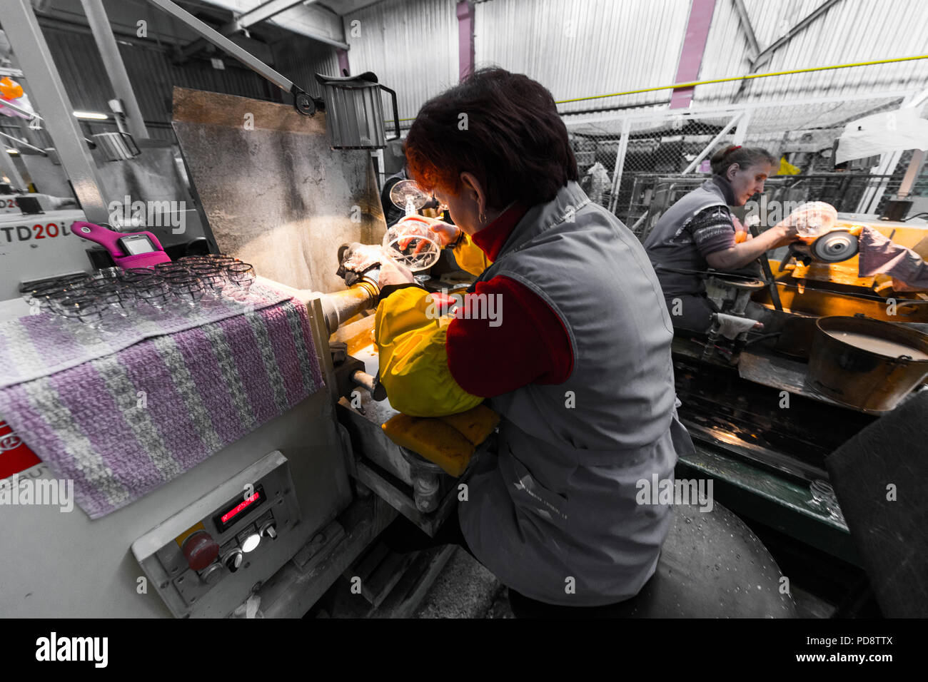 Glass production worker working with industry equipment on factory ...