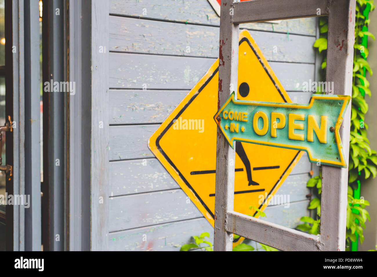 Open signboard arrow steel on shop door Stock Photo - Alamy
