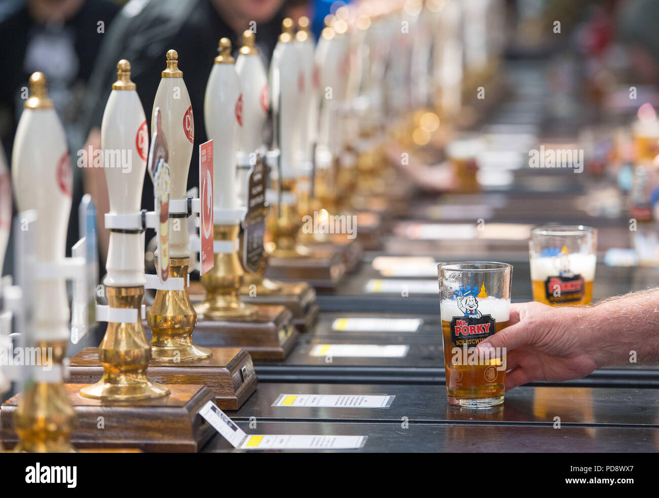 A visitor buys a drink during the CAMRA Great British Beer Festival at ...